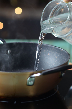 Now take another deep bottom pan and boil water in it.